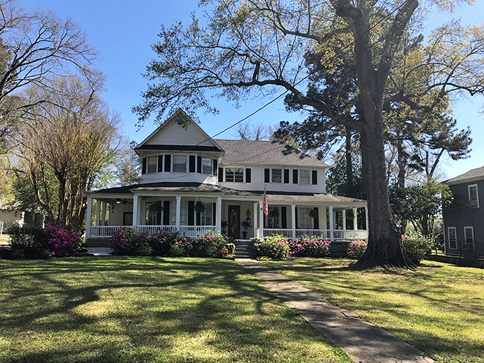 Southern hospitality incarnate: wraparound porches, mature shade trees, and flowers that seem to bloom just to make your day better.