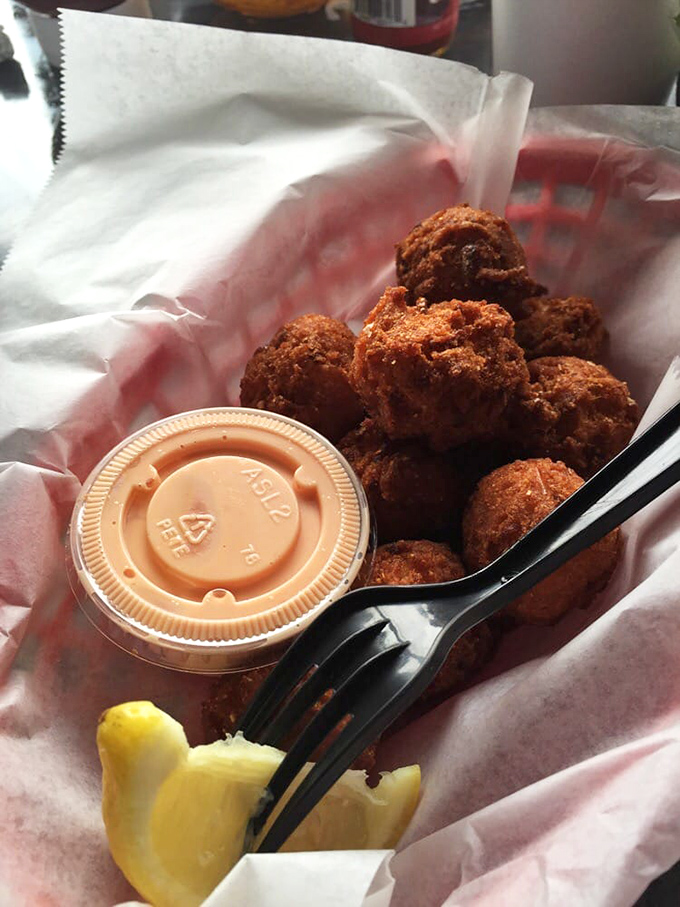 Hush puppies so perfectly golden they deserve their own trophy. That dipping sauce isn't optional &ndash; it's mandatory deliciousness.