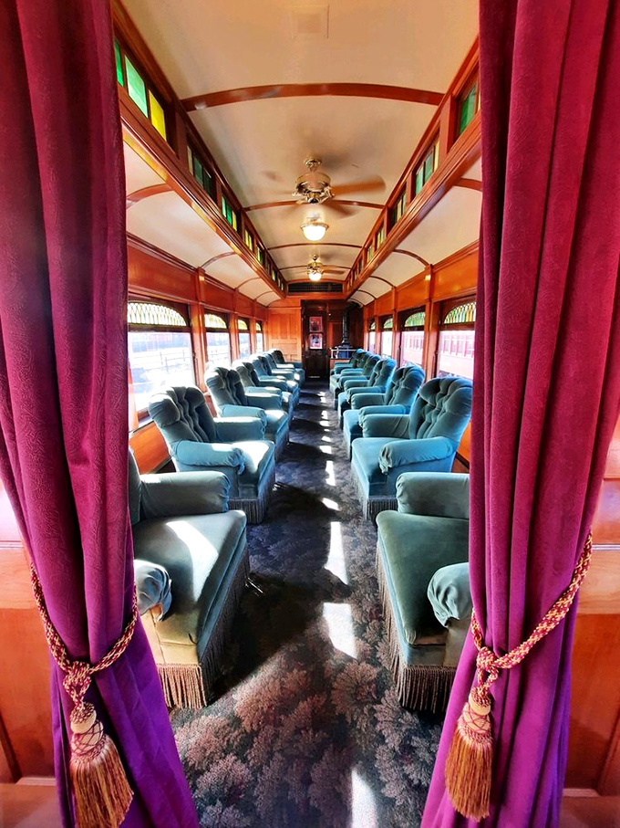Plush velvet seats invite passengers to travel in Gilded Age splendor. Sunlight streams through stained glass, painting the interior with kaleidoscope warmth.