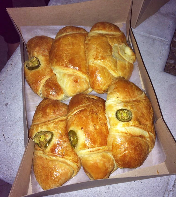 Jalape&ntilde;os peek out like tiny green sentinels, guarding the precious cargo of ham and cheese within these golden croissant fortresses.