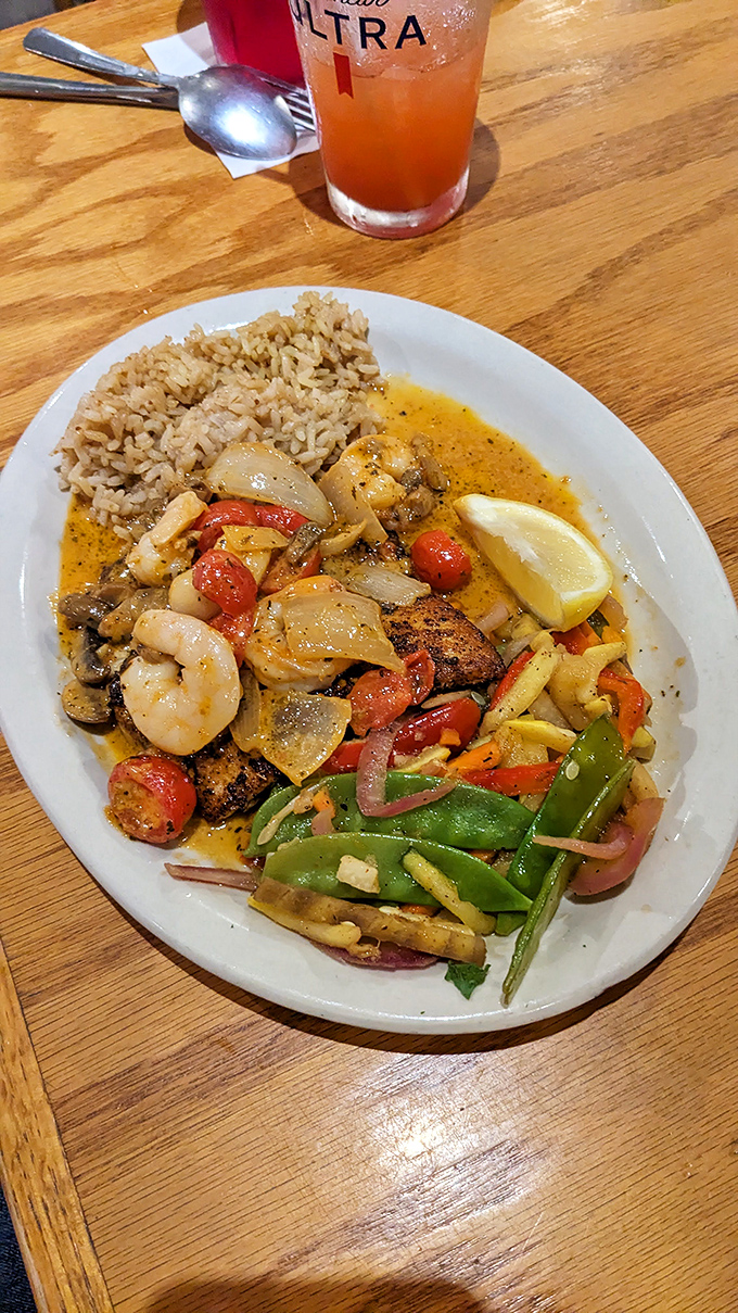 A colorful seafood medley dancing in sauce alongside perfectly cooked rice. Every bite offers a different combination of flavors&mdash;like a tasty treasure hunt on your plate. 