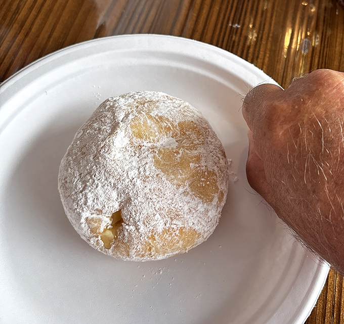 This powdered donut isn't playing games&mdash;it's the dessert equivalent of a magic trick waiting to reveal its sweet secret.