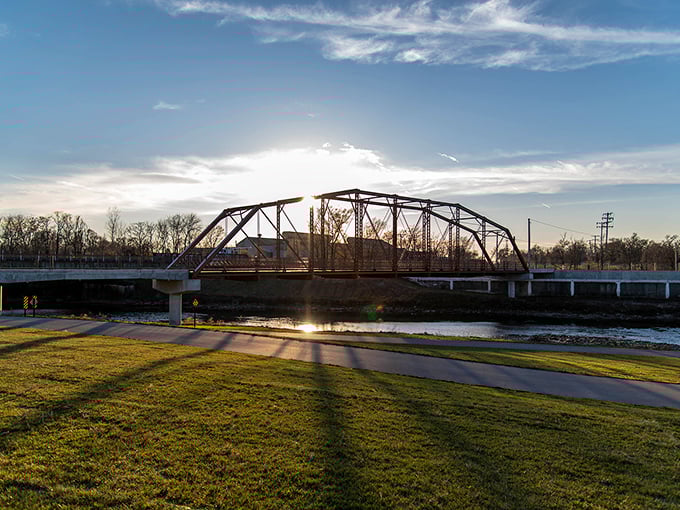 Sunset gilds Kitselman Bridge with golden light, transforming an everyday crossing into a postcard moment that costs nothing but appreciation.