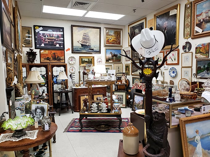 Wall-to-wall artwork creates a gallery feel in this vendor space. That coat rack could tell stories from the Roaring Twenties.