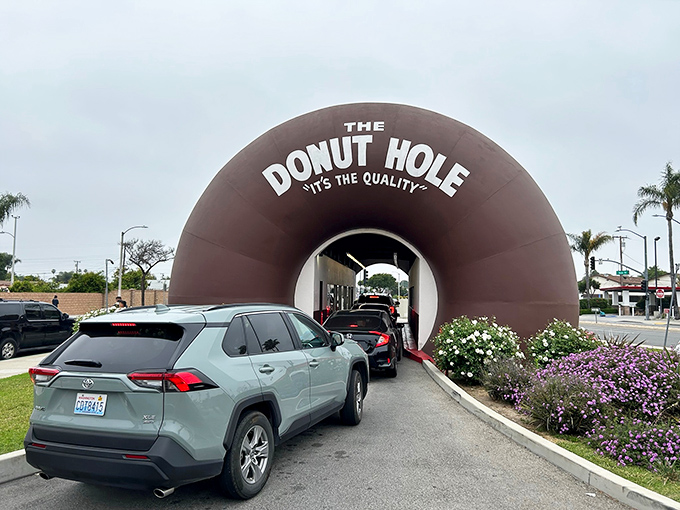 The line forms early as locals and tourists alike queue up for their chance to experience the thrill of the drive-through donut.
