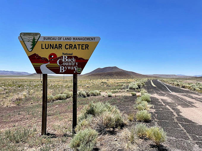 The Lunar Crater Back Country Byway sign points adventurers toward landscapes so otherworldly that NASA has used similar terrain to prepare for actual moon missions.