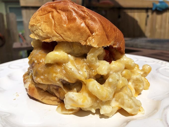 The burger that broke Instagram—mac and cheese spilling gloriously from a perfectly toasted bun. It's the food equivalent of winning the lottery and finding true love on the same day.