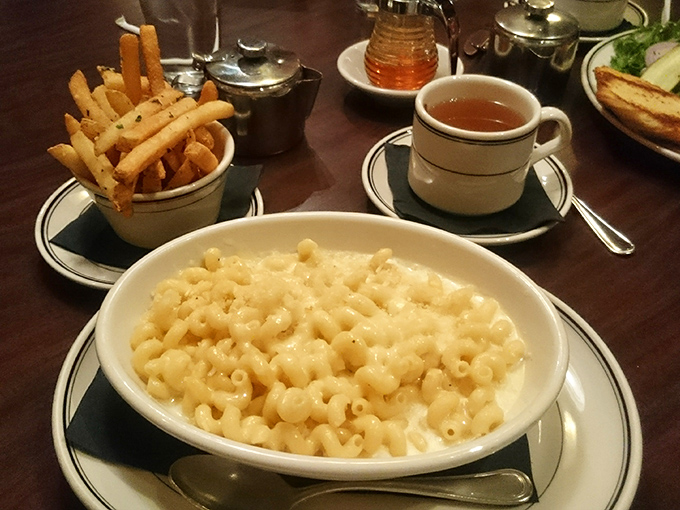 The perfect pairing: golden fries standing at attention beside a bowl of pure, unadulterated mac and cheese. Carb heaven exists, and it's right here.