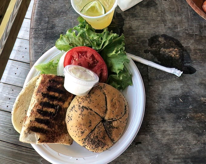 Simple perfection: fresh fish, crisp lettuce, ripe tomato, and a toasted bun. Sometimes the best seafood comes on a paper plate.