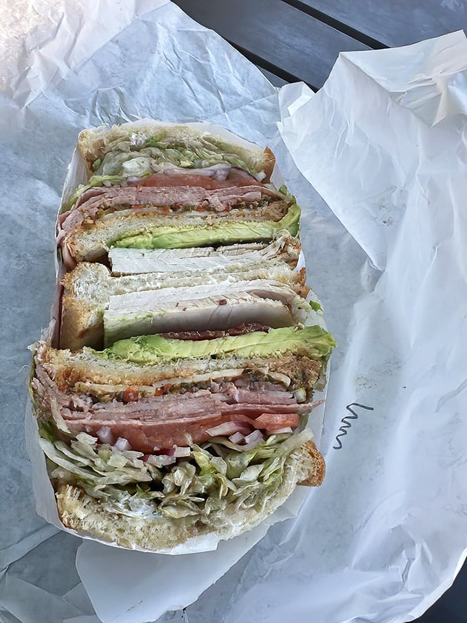 The cross-section reveals the sandwich equivalent of geological strata—each layer of meat, cheese, and veggies telling its own delicious story.