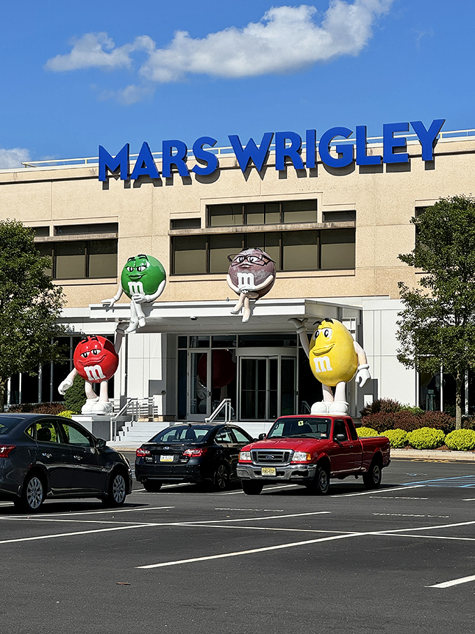 The Mars Wrigley factory, where dreams and M&M's are made in equal measure. Those colorful characters standing guard might be the happiest corporate mascots in existence.