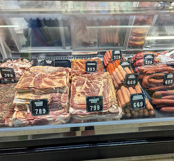 A carnivore's dream display where bacon, sausage, and specialty cuts line up like delicious soldiers ready for your breakfast battalion.