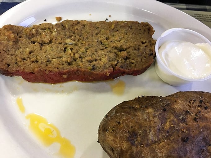 The meatloaf arrives like a work of art&mdash;perfectly seasoned, with a side of butter-kissed baked potato and a dollop of sour cream for good measure.