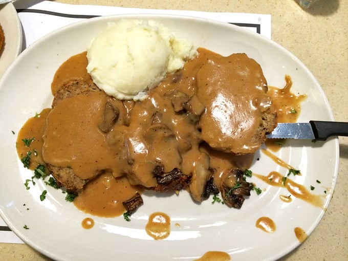 The meatloaf and mashed potato volcano erupts with mushroom gravy lava. A comfort food masterpiece that would make grandmothers everywhere nod in approval.