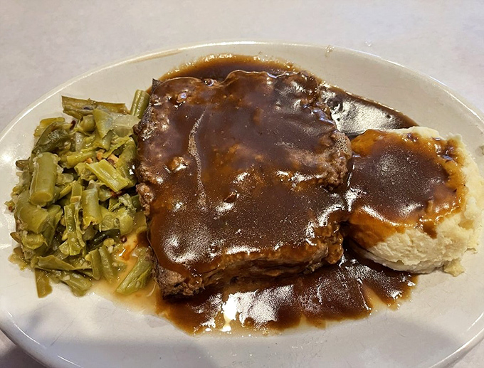 Gravity-defying gravy that somehow manages to coat every bite perfectly. This meatloaf doesn't need a filter—it needs a monument.