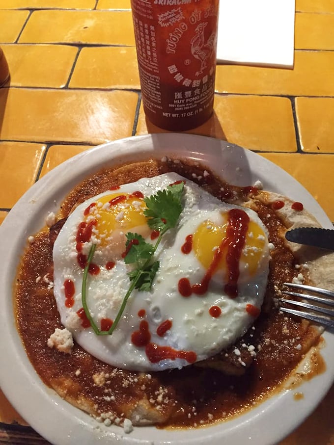 Sunny-side up eggs lounging on a pancake like they're at a Florida beach resort, complete with hot sauce sunscreen. Vacation on a plate.
