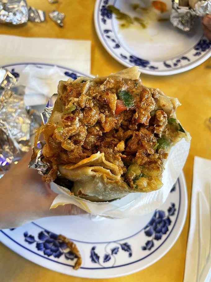 The architecture of a proper Mission-style burrito revealed. That perfectly melted cheese barrier isn't just delicious—it's structural engineering at its most delectable.