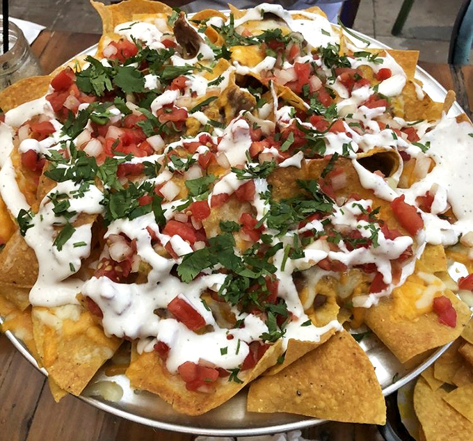 The nacho motherload has arrived! Golden chips supporting a perfect distribution of toppings&mdash;no sad, naked chips hiding at the bottom of this masterpiece.
