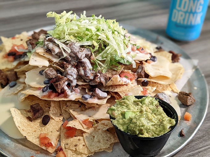 That side of guacamole isn't just a condiment&mdash;it's the emerald crown jewel in this royal feast of perfectly layered nachos.