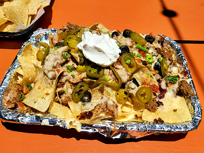 Nachos served in a foil tray&mdash;not because they're fancy, but because they need industrial-strength containment for all that melty, jalape&ntilde;o-studded goodness.