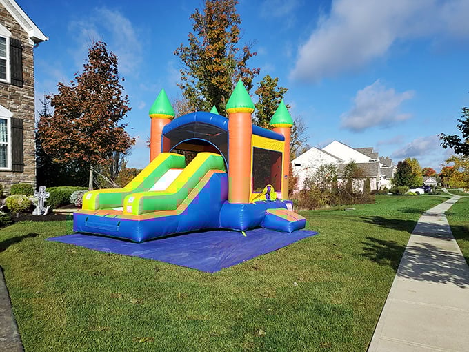 Nothing says "childhood summer memories" quite like a bouncy castle on a perfect lawn. The neighborhood kids probably think this is completely normal.