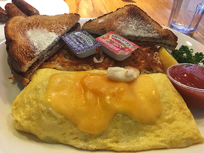 Behold the cheese omelet in its golden glory, flanked by crispy hashbrowns and toast &ndash; breakfast's holy trinity on a single plate.
