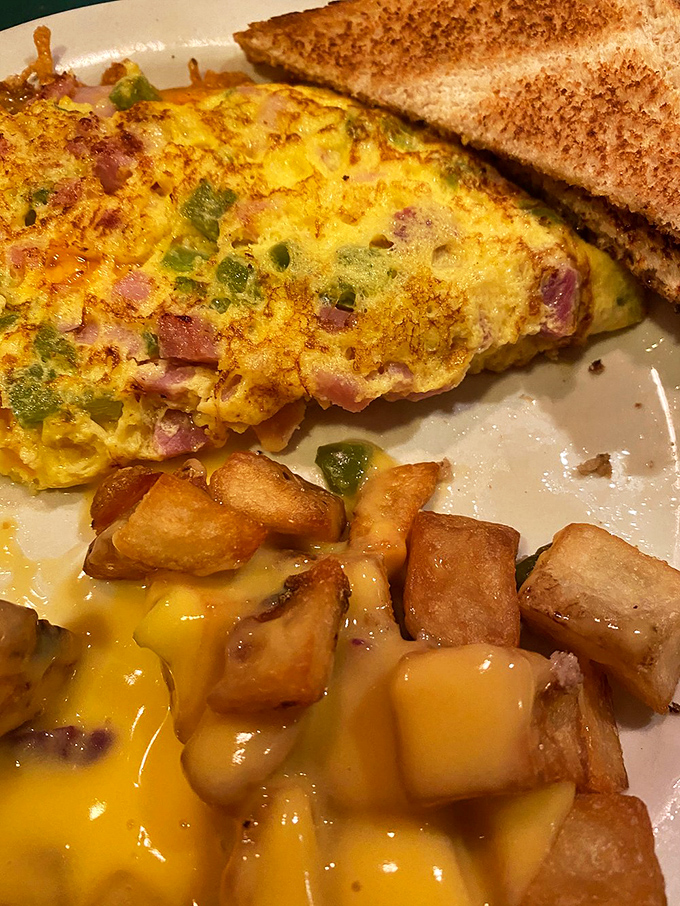 This isn't just an omelet&mdash;it's a masterpiece of morning architecture with ham, peppers, and cheese playing supporting roles to those perfect eggs.
