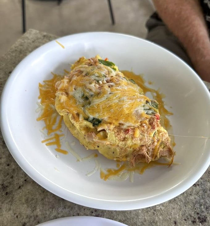 An omelet that's had proper training&mdash;perfectly folded, generously filled, and topped with just enough cheese to make you smile without overwhelming.
