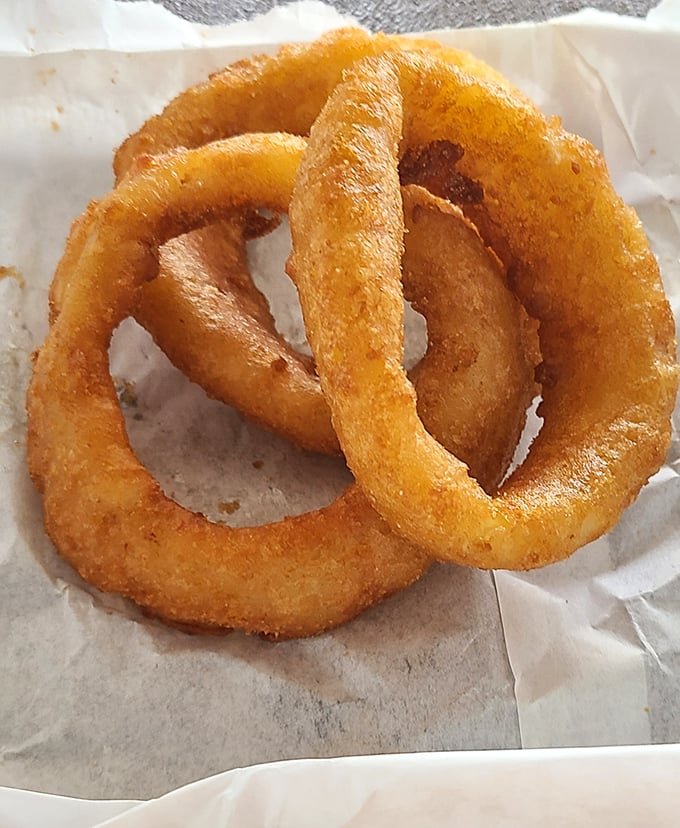 Golden halos of deep-fried perfection. These onion rings aren't just a side dish&mdash;they're the supporting actors that sometimes steal the show.