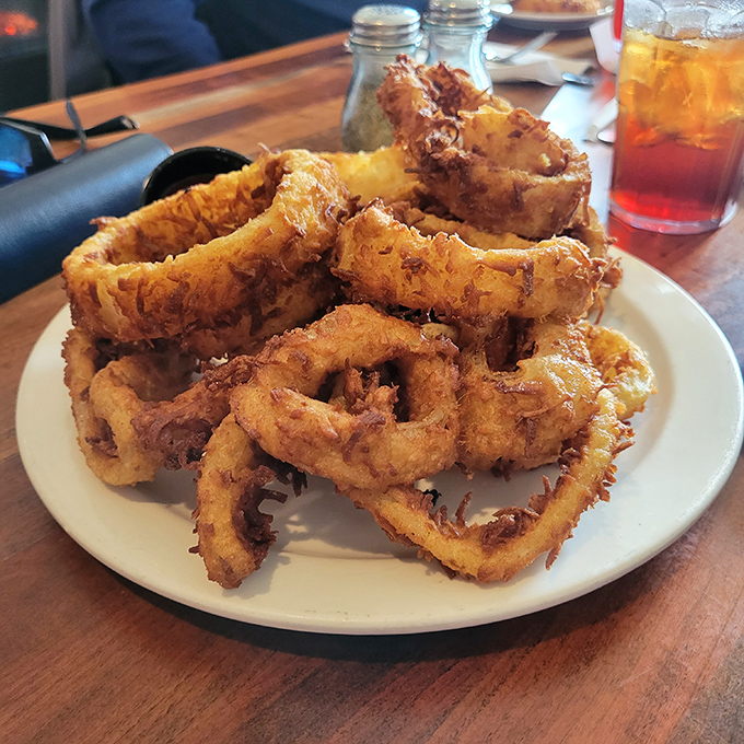 Golden halos of happiness! These onion rings achieve that mythical balance of crispy exterior and tender interior that keeps you reaching for more.