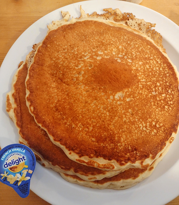 Pancakes stacked higher than my college textbooks, with the perfect golden-brown hue that says "I was made with care, not haste."