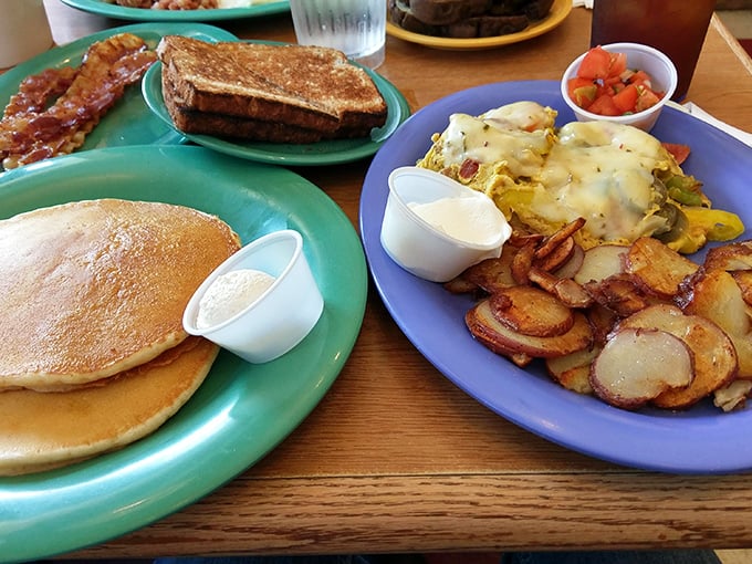 The breakfast holy trinity: fluffy pancakes, a cheese-laden omelet, and those addictive home fries that somehow manage to be both crispy and tender.