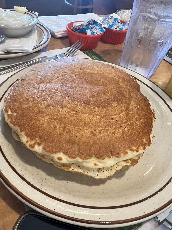 That pancake isn't just large &ndash; it's practically claiming territorial rights on the plate. Golden-brown perfection that makes syrup the luckiest condiment in Florida.