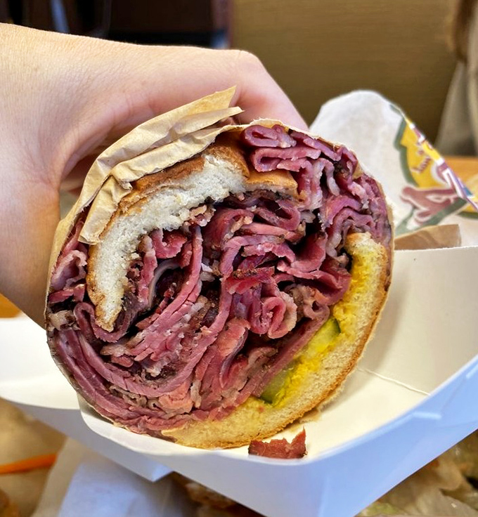 The pastrami sandwich that launched a thousand food dreams. More meat than should legally fit between two slices of bread. New York delis would approve.