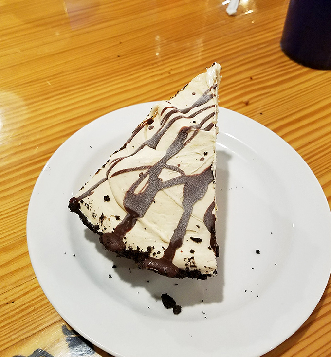 Dessert architecture at its finest&mdash;a slice of chocolate-drizzled pie that makes you contemplate ordering a second piece before finishing the first.