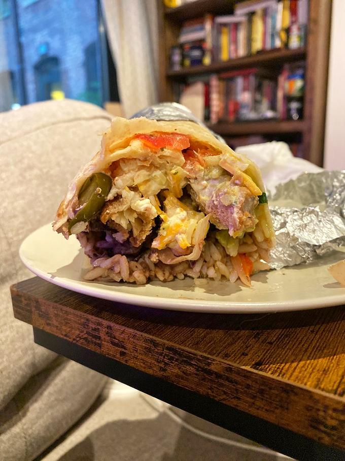 Cross-section perfection reveals the careful layering that makes each bite a complete experience. This burrito doesn't just satisfy hunger—it tells a story.
