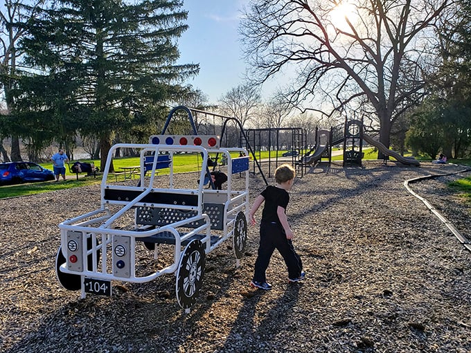 Childhood joy meets imaginative design. This playground's mini police car lets kids patrol the fun while parents enjoy the park's natural serenity.