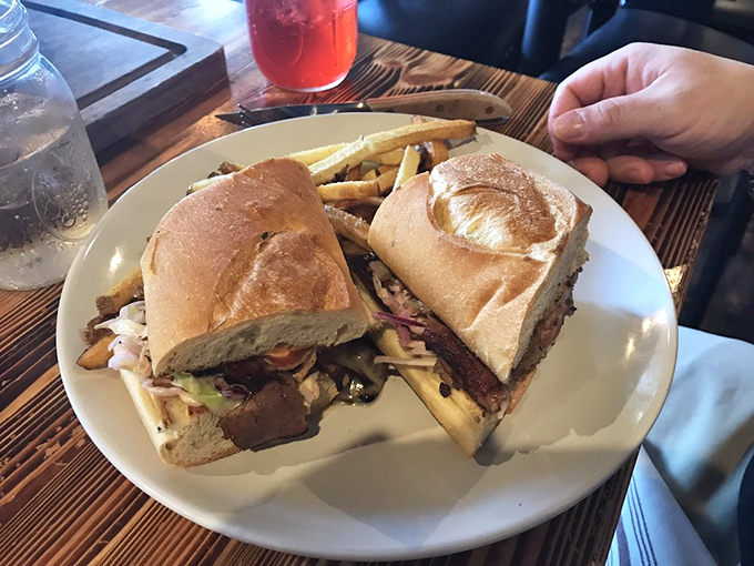 This isn't just a sandwich; it's architecture. Layers of deliciousness housed between bread walls that barely contain their savory treasures.