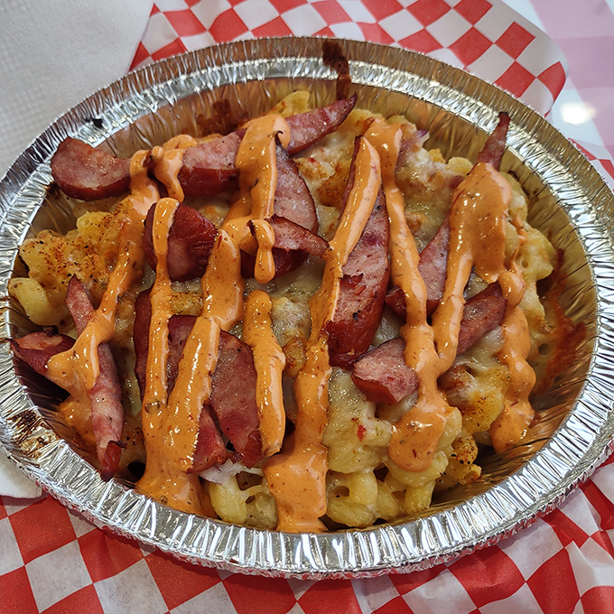 Sliced sausage and orange sauce drizzle transform ordinary mac into extraordinary indulgence. Like pasta wearing its Sunday best.