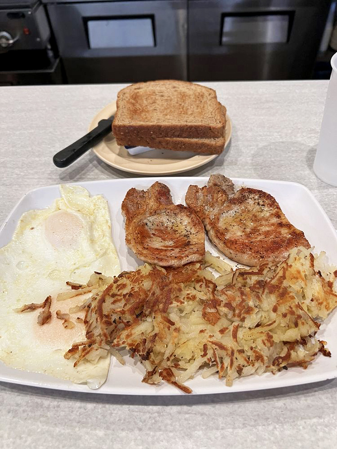 Pork chops and eggs&mdash;the breakfast of champions who have no plans to move for the next several hours. Those hash browns deserve their own fan club.