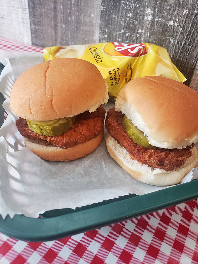 The pork tenderloin sandwich: where the meat decided to vastly outgrow its bun and nobody complained about the overachievement.