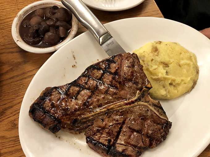 The T-bone doesn't just sit on the plate&mdash;it commands it, flanked by mashed potatoes and mushrooms like loyal subjects to beef royalty.