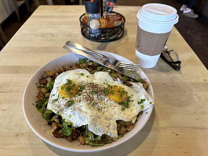 Breakfast bowl brilliance: perfectly cooked eggs crowning a kingdom of seasoned potatoes. The kind of morning fuel that makes coffee jealous.
