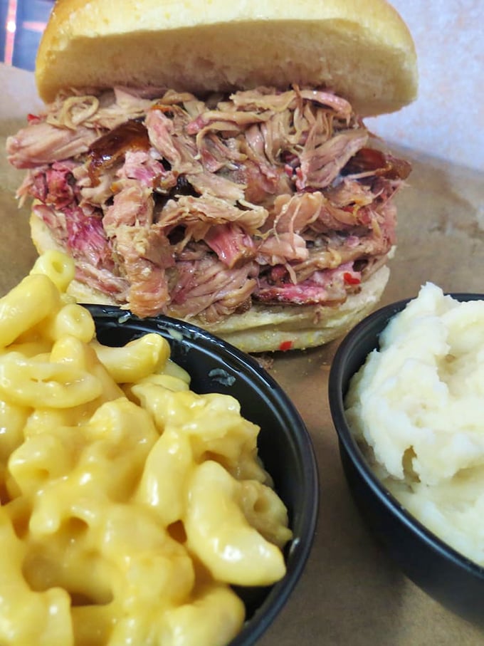 A pulled pork sandwich that doesn't skimp on the main attraction, flanked by mac and cheese that's clearly not from any blue box.
