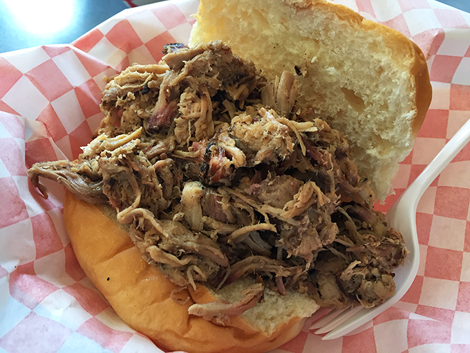 Pulled pork perfection on a bun&mdash;tender strands of smoky meat piled high, just waiting to transport you to barbecue nirvana.