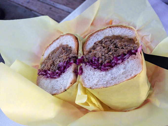 The pulled pork sandwich doesn't whisper, it announces itself—tender meat, vibrant slaw, and a bun that knows its supporting role perfectly.