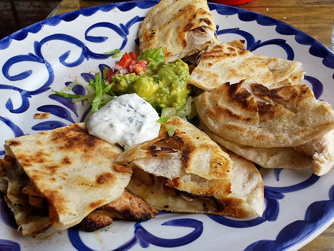 Quesadillas that achieve the golden ratio of crisp exterior to molten interior, served with the holy trinity of Mexican condiments &ndash; sour cream, guacamole, and pico.