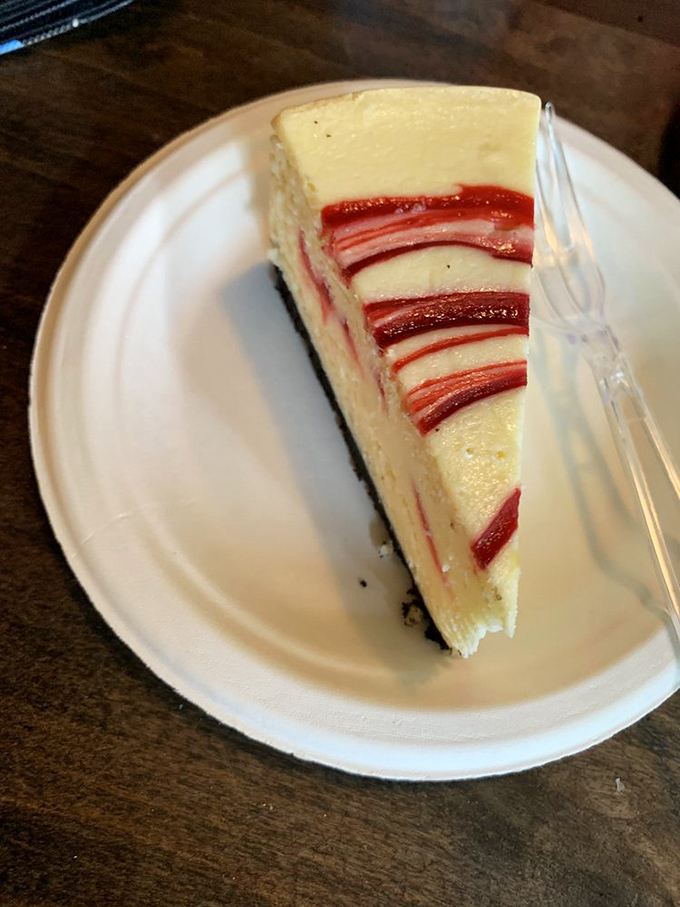 Those ruby-red ribbons of raspberry aren't just for show&mdash;they're flavor highways cutting through creamy cheesecake valleys. Visual deliciousness at its finest.