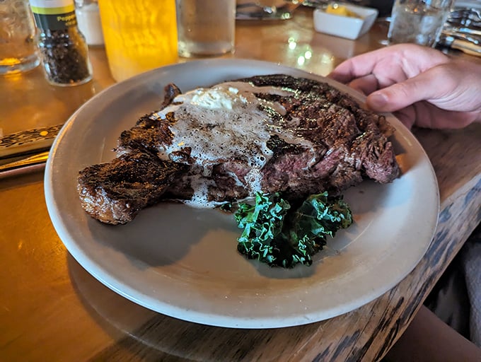 A steak so perfectly seared it could make a grown Wisconsinite weep, topped with a pat of butter melting into liquid gold.