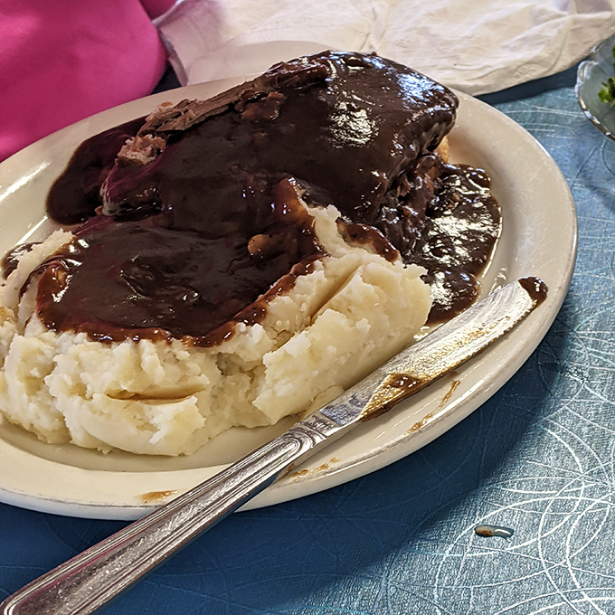 Meatloaf and mashed potatoes &ndash; the dynamic duo of diner cuisine. That gravy doesn't just cover the meat; it creates a savory lake that demands to be explored with each forkful.
